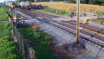 Cyclist Has The Mother Of All Close Calls With Oncoming Train | Carscoops