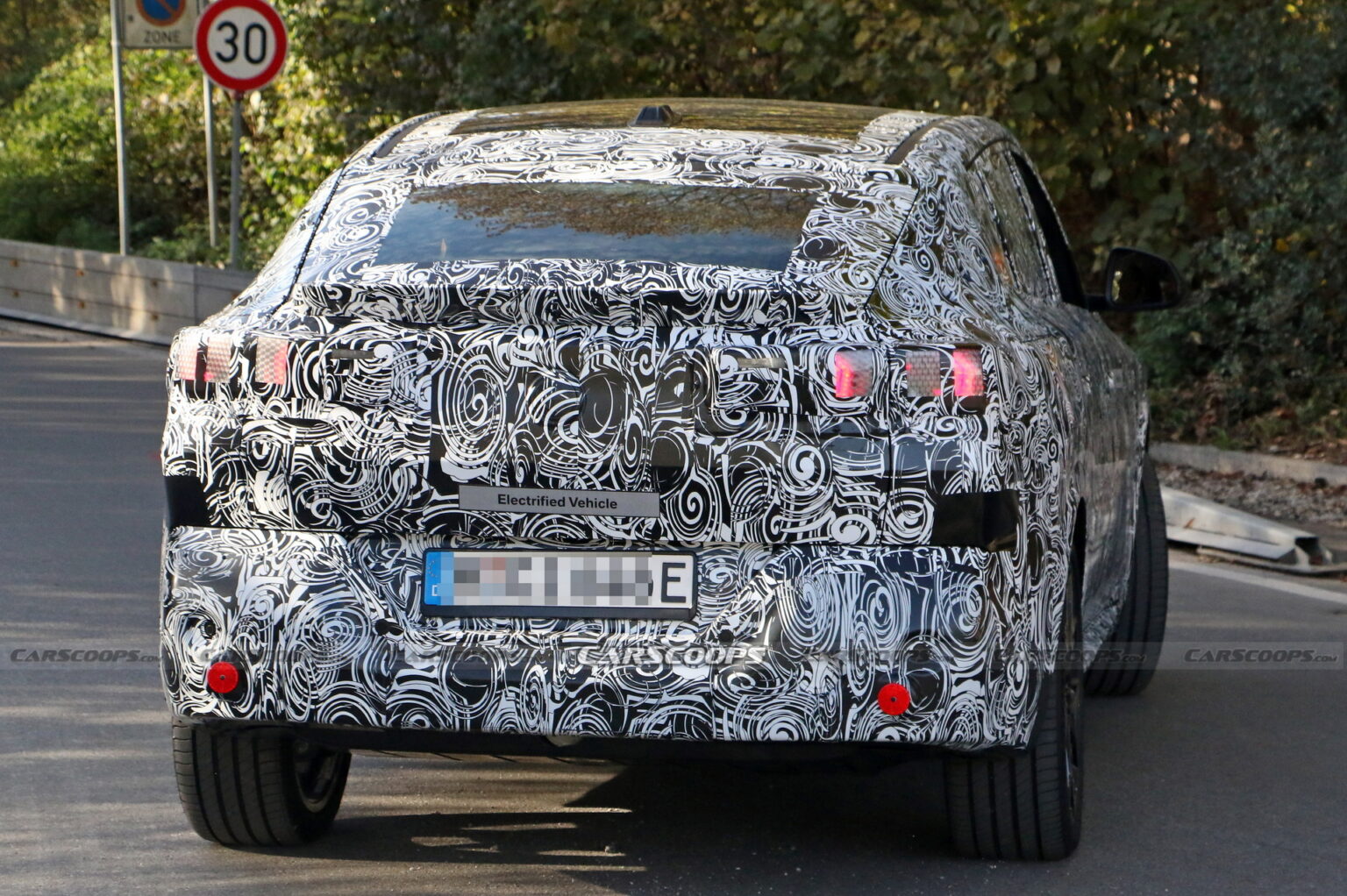 2024 BMW iX2 EV Spied With A Covered Grille And Sloping Roofline ...